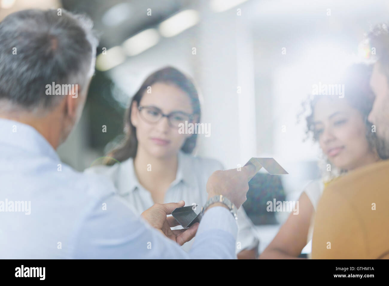Business people discussing prototype in meeting Stock Photo - Alamy