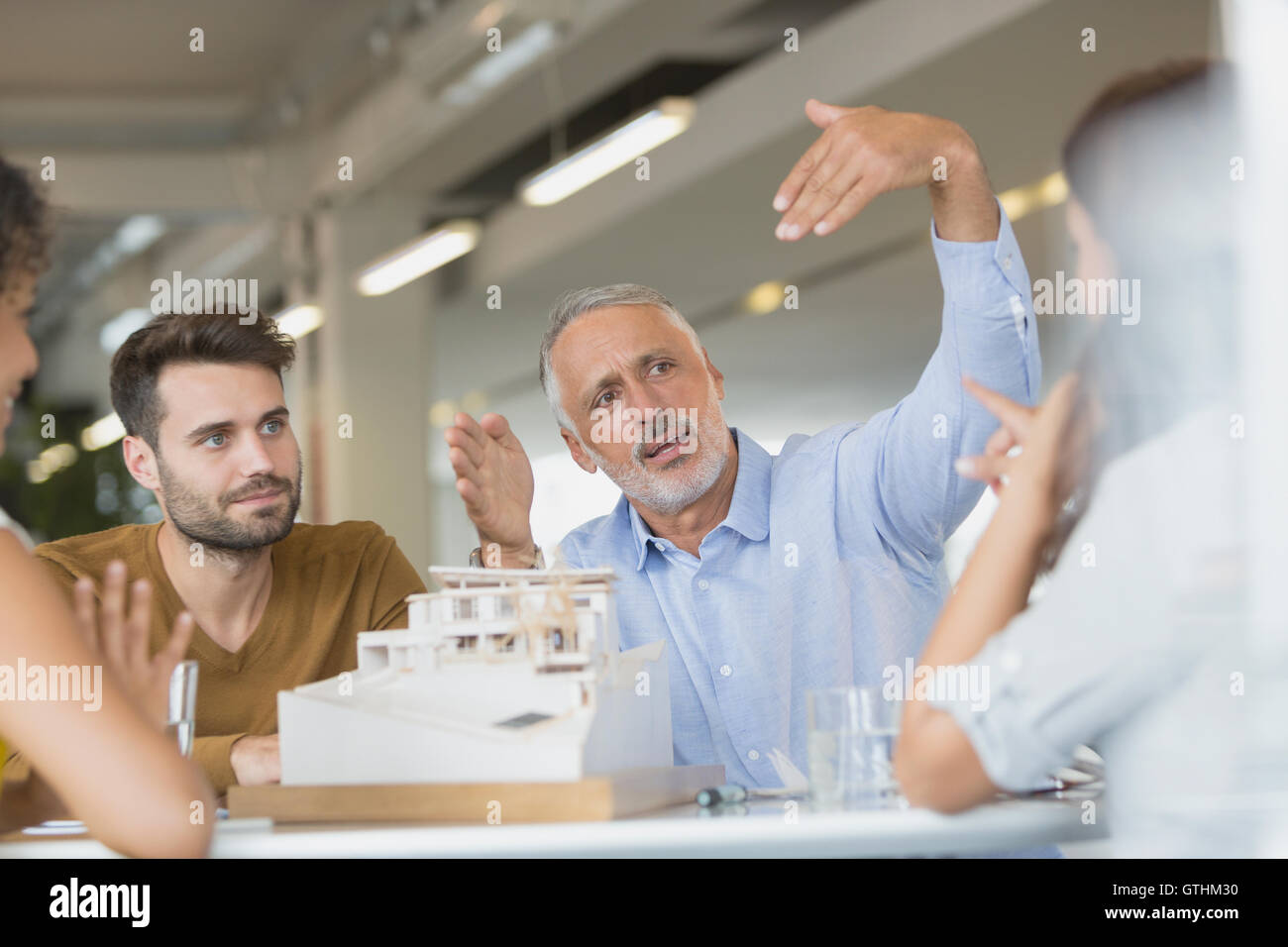Architects discussing model in meeting Stock Photo - Alamy
