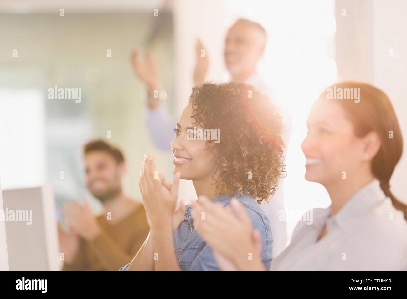 Businesswomen clapping in office Stock Photo - Alamy