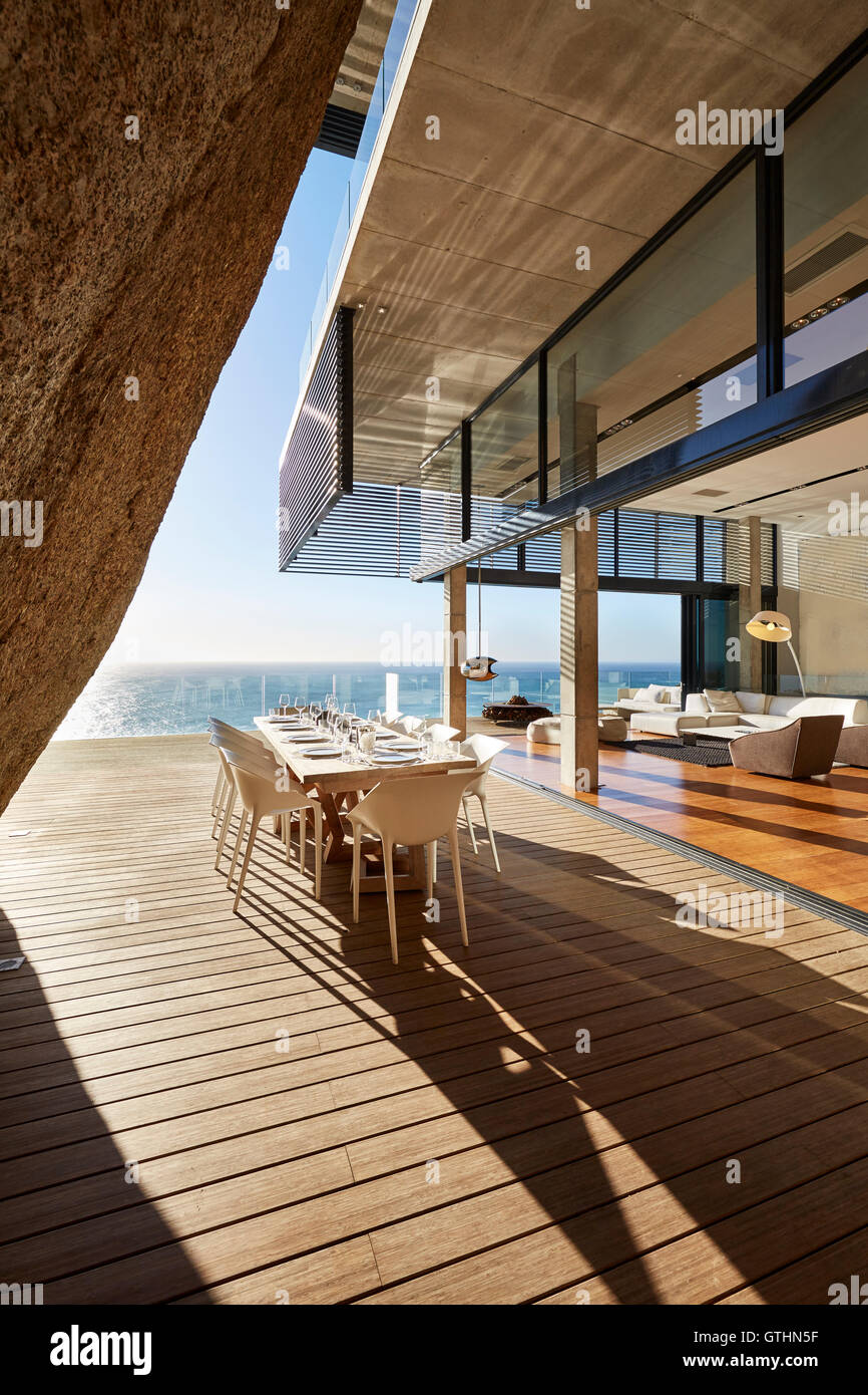 Modern luxury dining table on sunny patio with ocean view Stock Photo ...