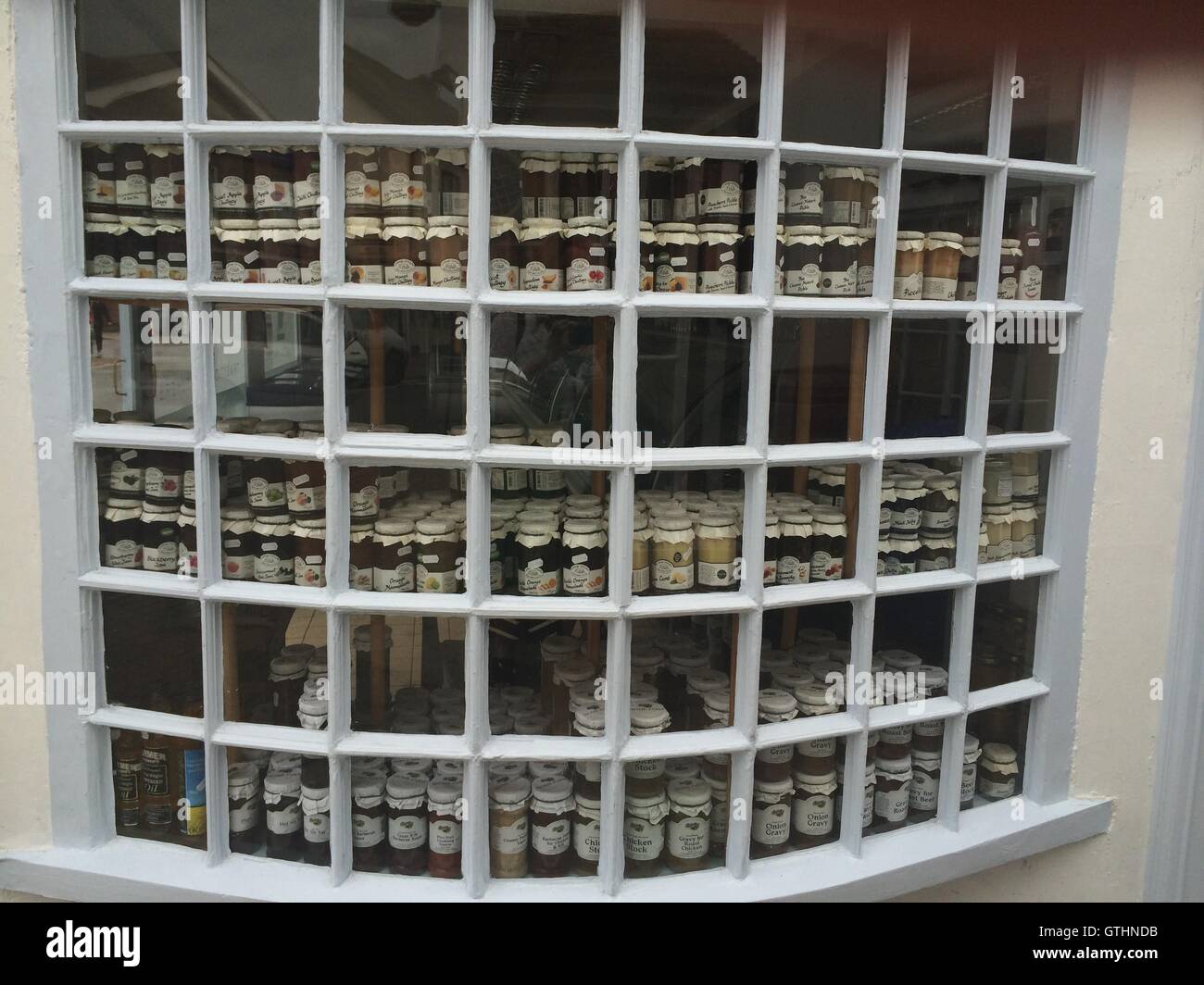 Jam jars through a curved window, Saffron Walden Stock Photo - Alamy