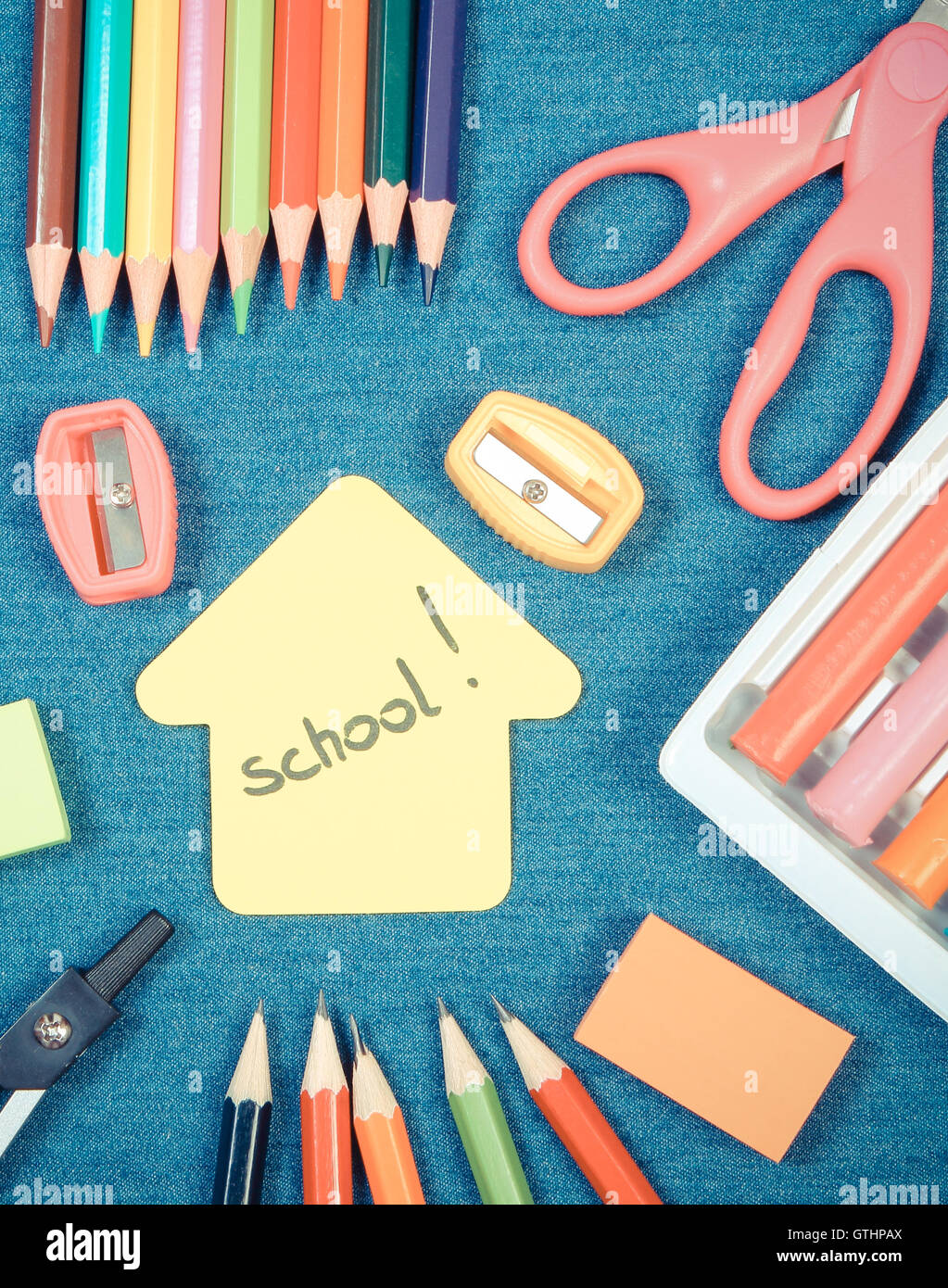 Vintage photo, School supplies on jeans background, shape of building ...