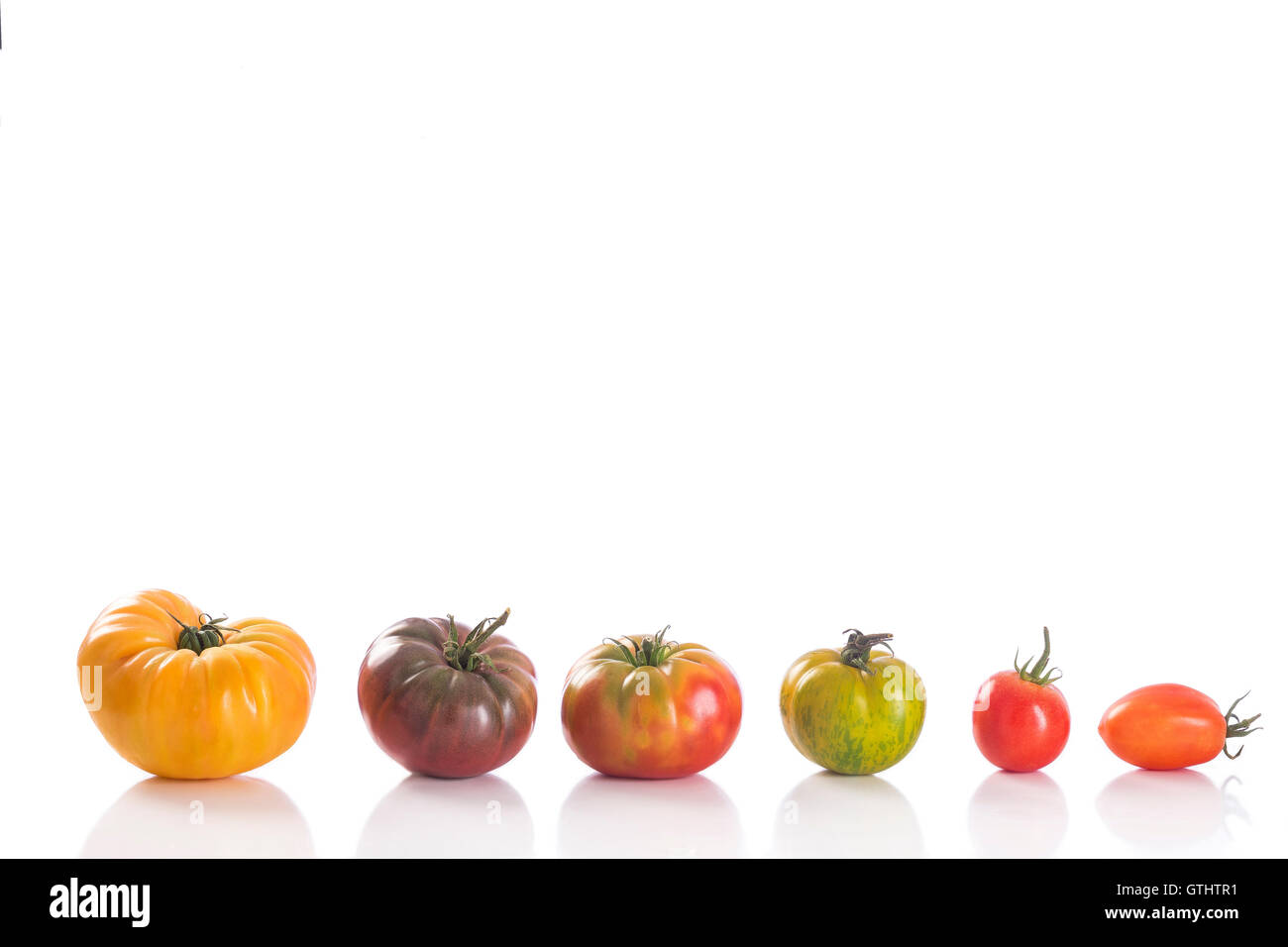 Variety of Heirloom tomatoes on white background Stock Photo - Alamy