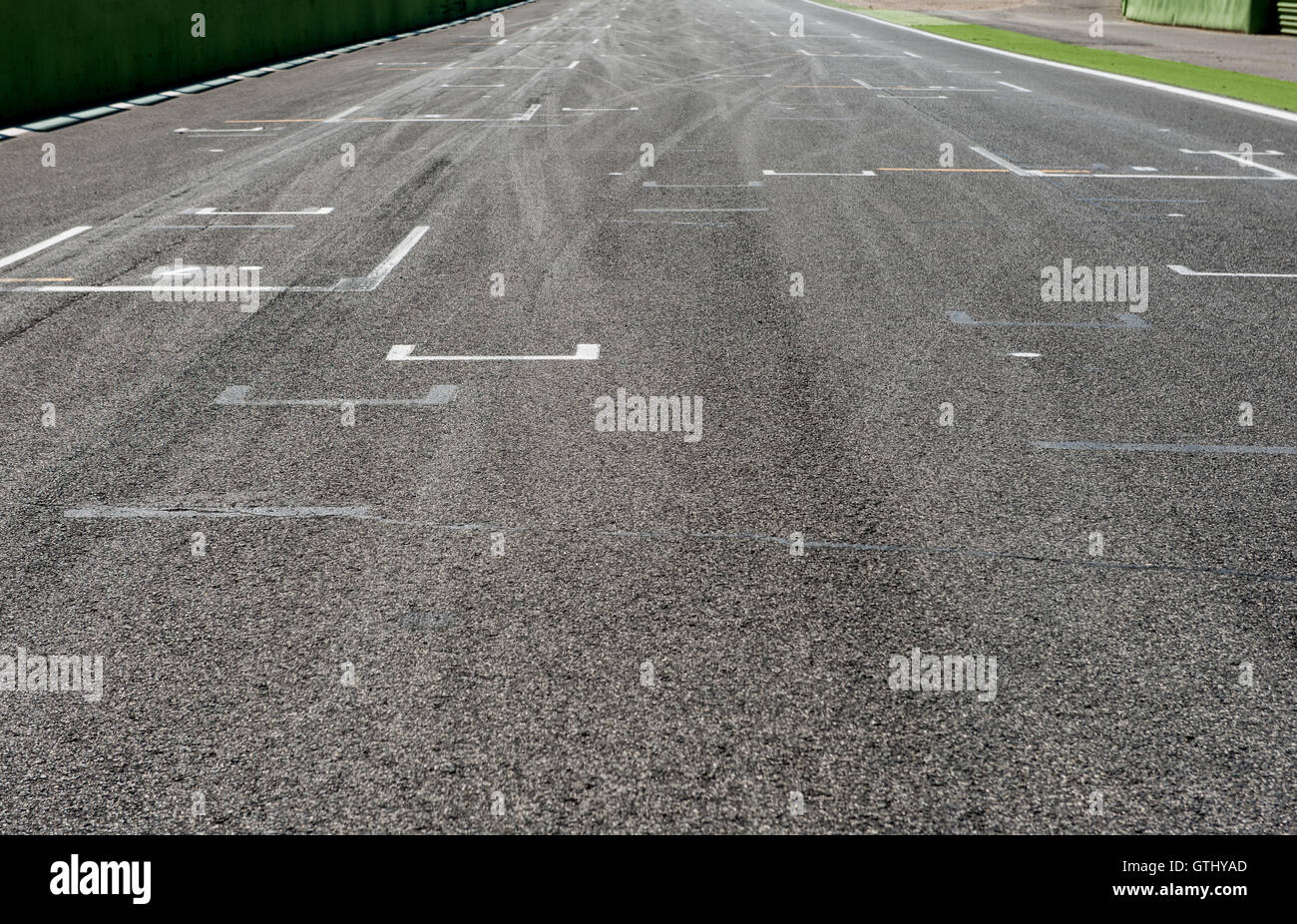 Motorsport asphalt with white start position sign on straight line ...