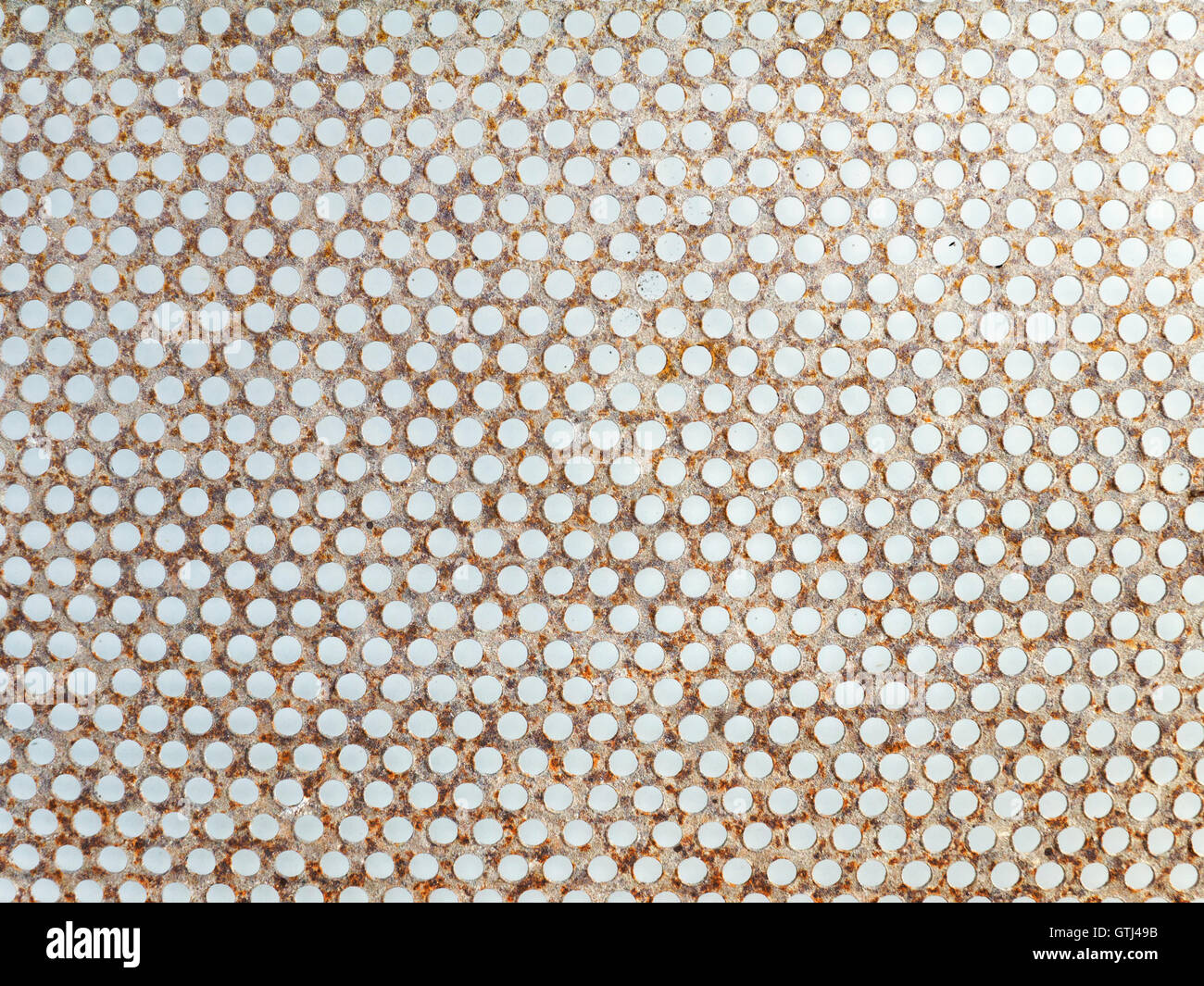 Rusty iron grille with round holes background Stock Photo - Alamy