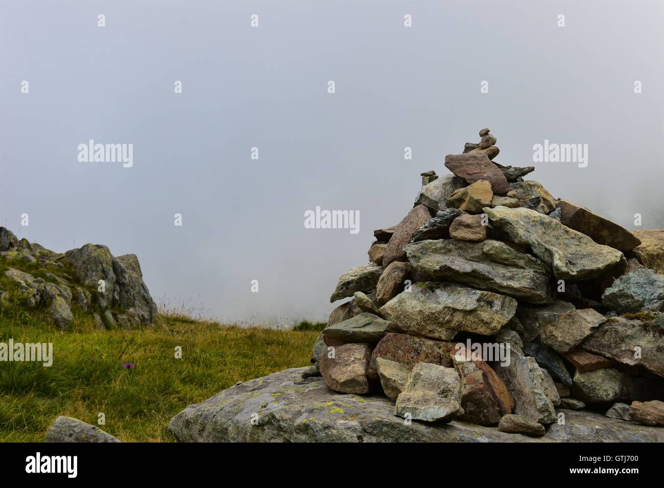 Beautiful mountains and valleys with steep rocks, paths and fog form ...