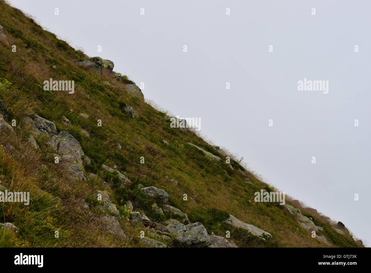 Beautiful mountains and valleys with steep rocks, paths and fog form ...