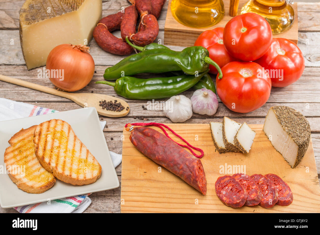 Differents spanish healthy food on a table, chorizo, cheese, tomatos ...