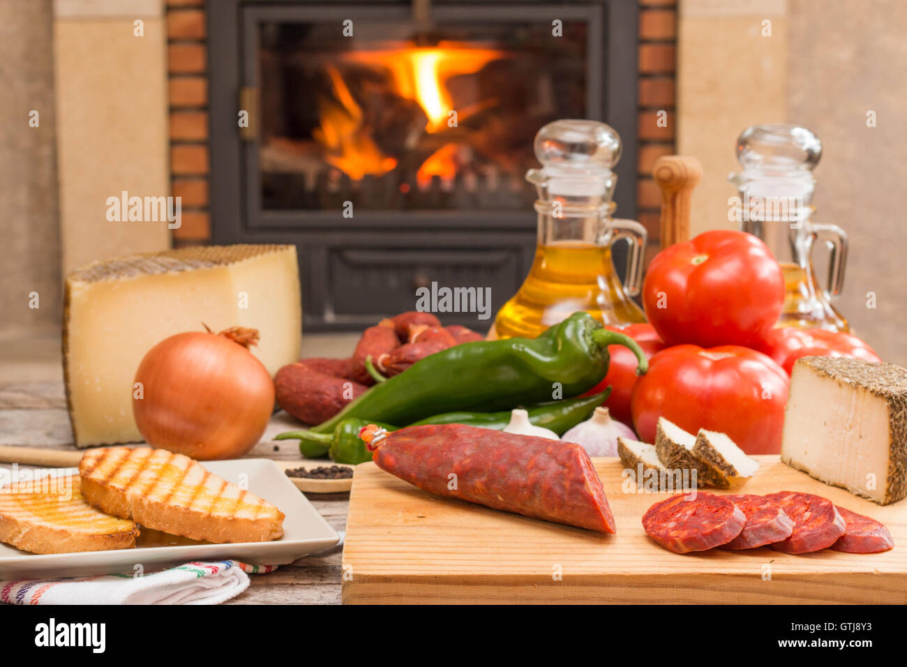 Differents spanish healthy food on a table, chorizo, cheese, tomatos ...