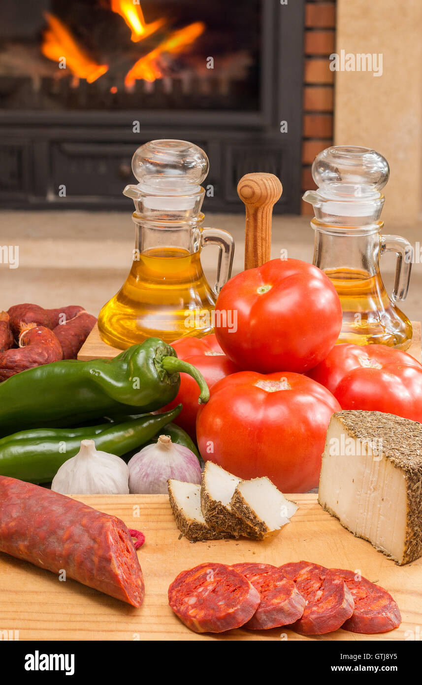Differents spanish healthy food on a table, chorizo, cheese, tomatos ...
