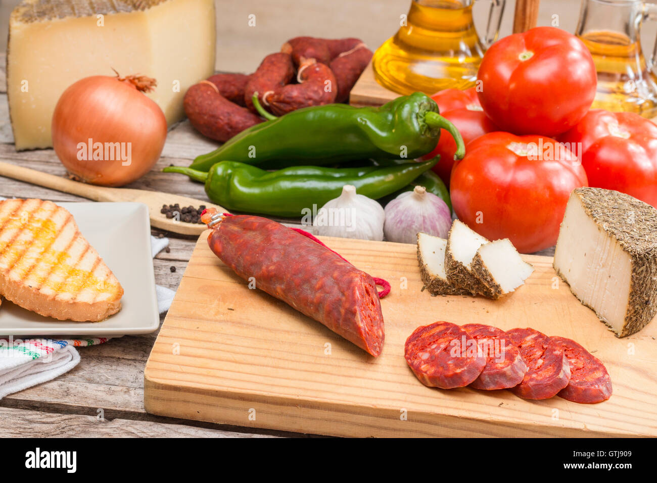 Differents spanish healthy food on a table, chorizo, cheese, tomatos ...