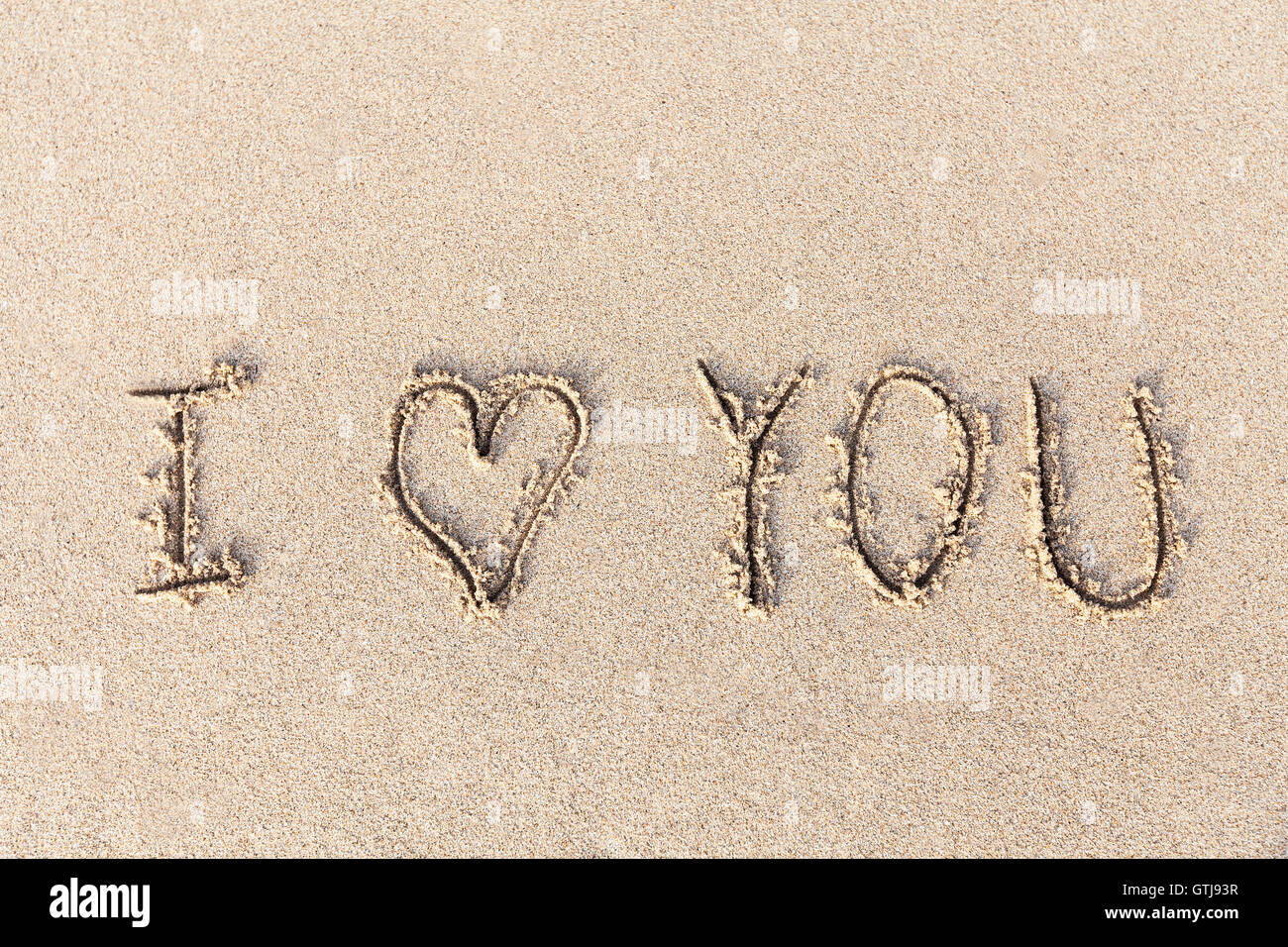 I love you handwritten in sand for natural Stock Photo - Alamy