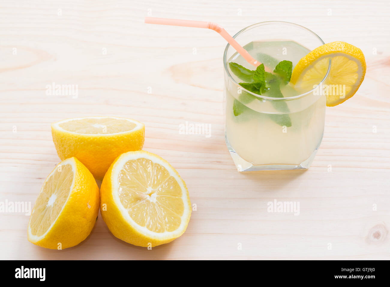 Glass of natural lemonade just squeezed on wooden table Stock Photo - Alamy