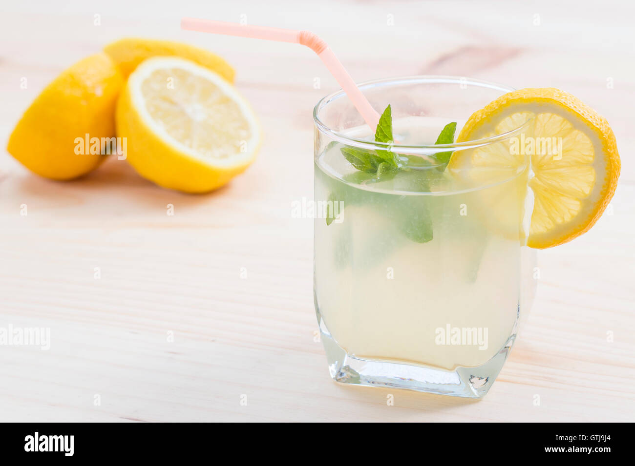Glass of natural lemonade just squeezed on wooden table Stock Photo - Alamy