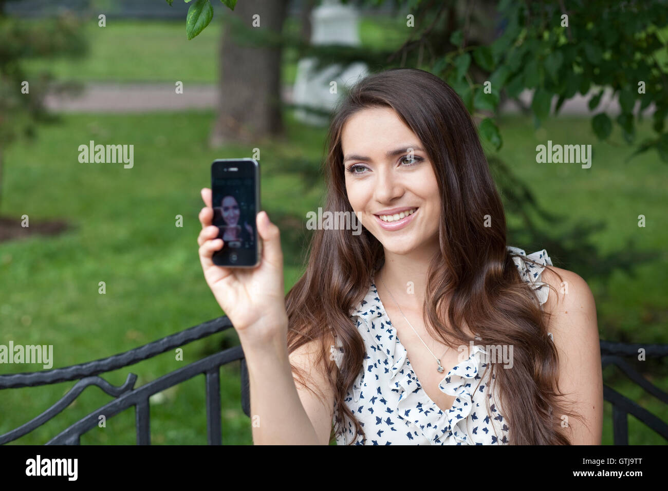 Happy young woman taking pictures on your phone Stock Photo - Alamy