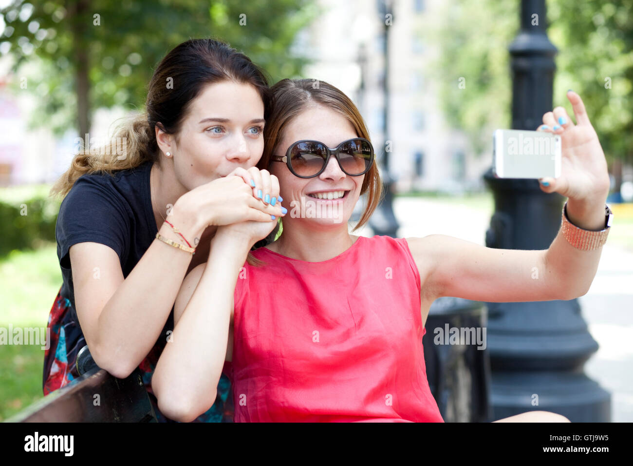 Happy young women taking pictures on your phone Stock Photo - Alamy