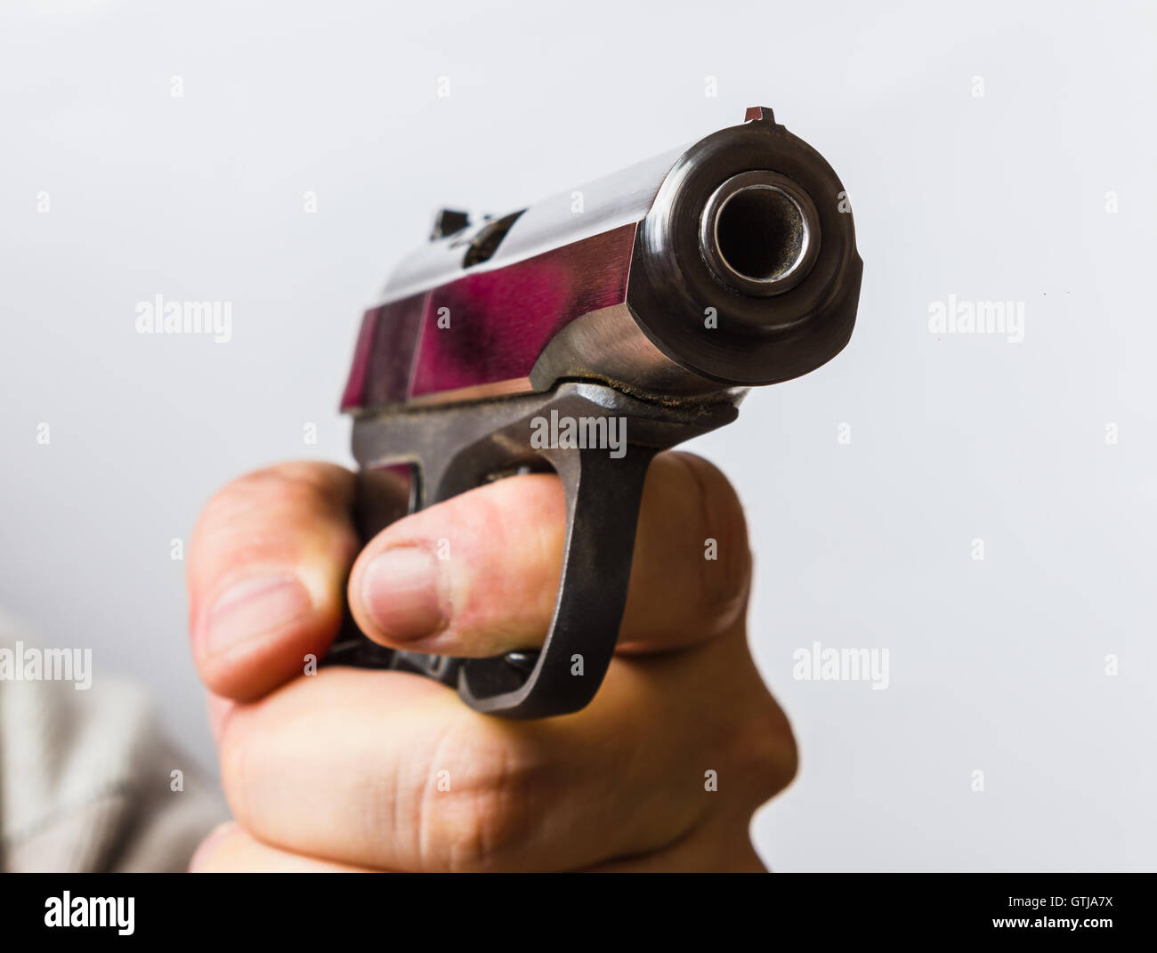 man with a black gun in his hand Stock Photo - Alamy