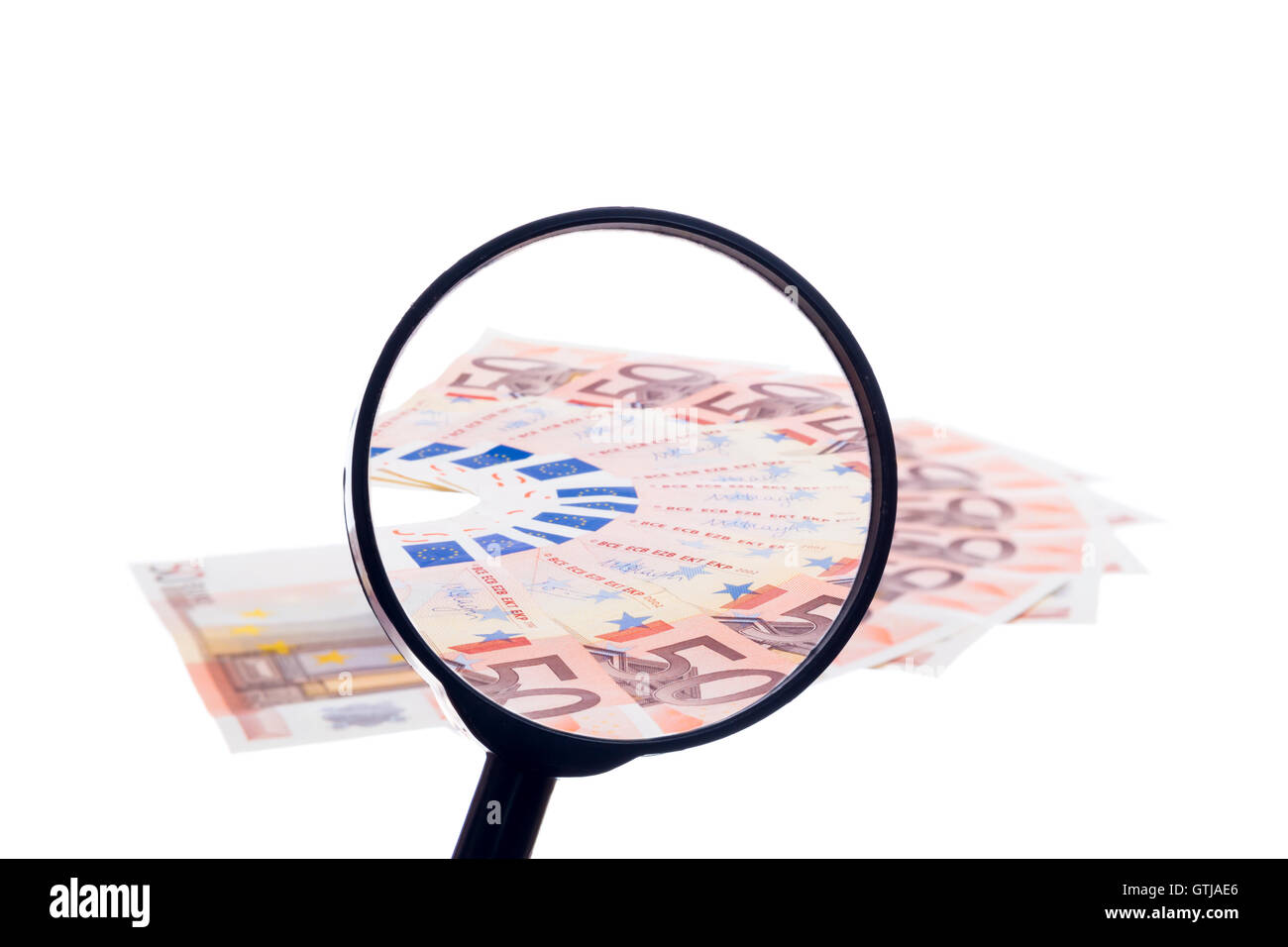 Money through magnifying glass Cut Out Stock Images & Pictures - Alamy