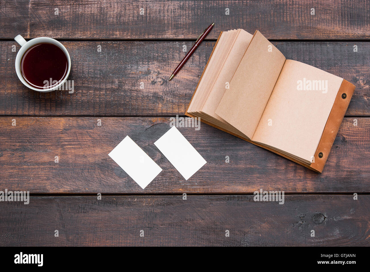 Office desk table with cup, notebook, cards on wooden table Stock Photo ...