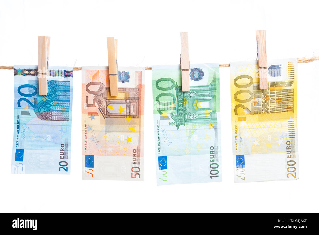 Euro banknotes hanging with peg from a rope isolated on white ...