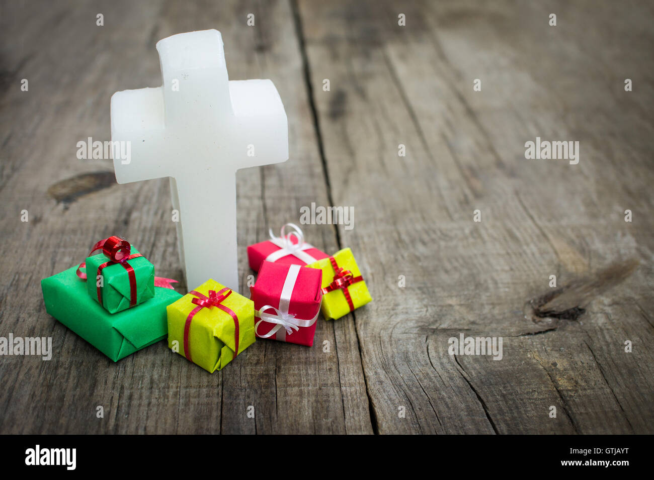 Religious cross with presents Stock Photo - Alamy