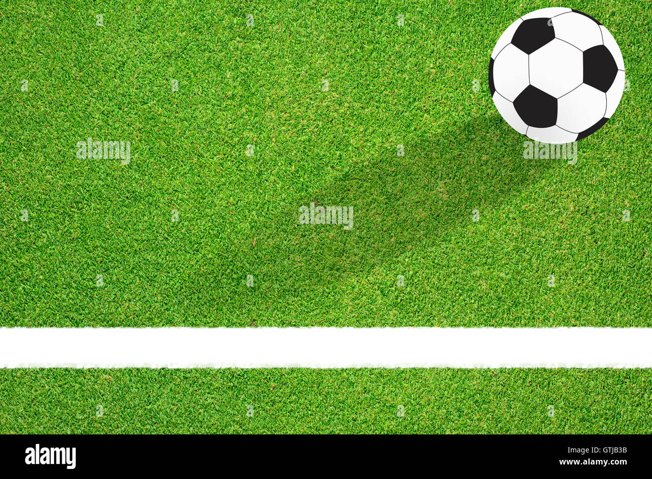 Football on green grass background Stock Photo - Alamy