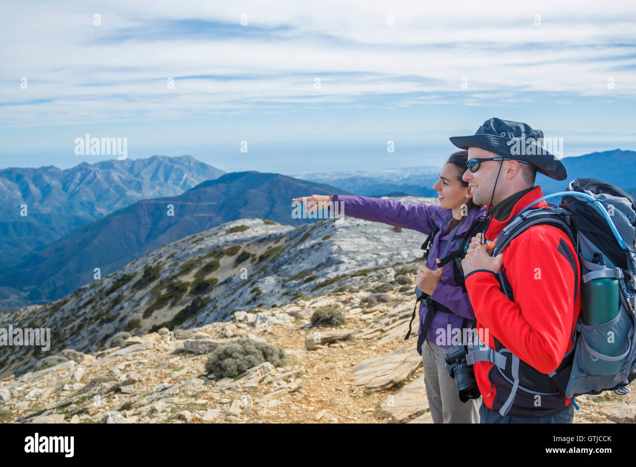 Young adult couple hiker pointing at the mountains Stock Photo - Alamy