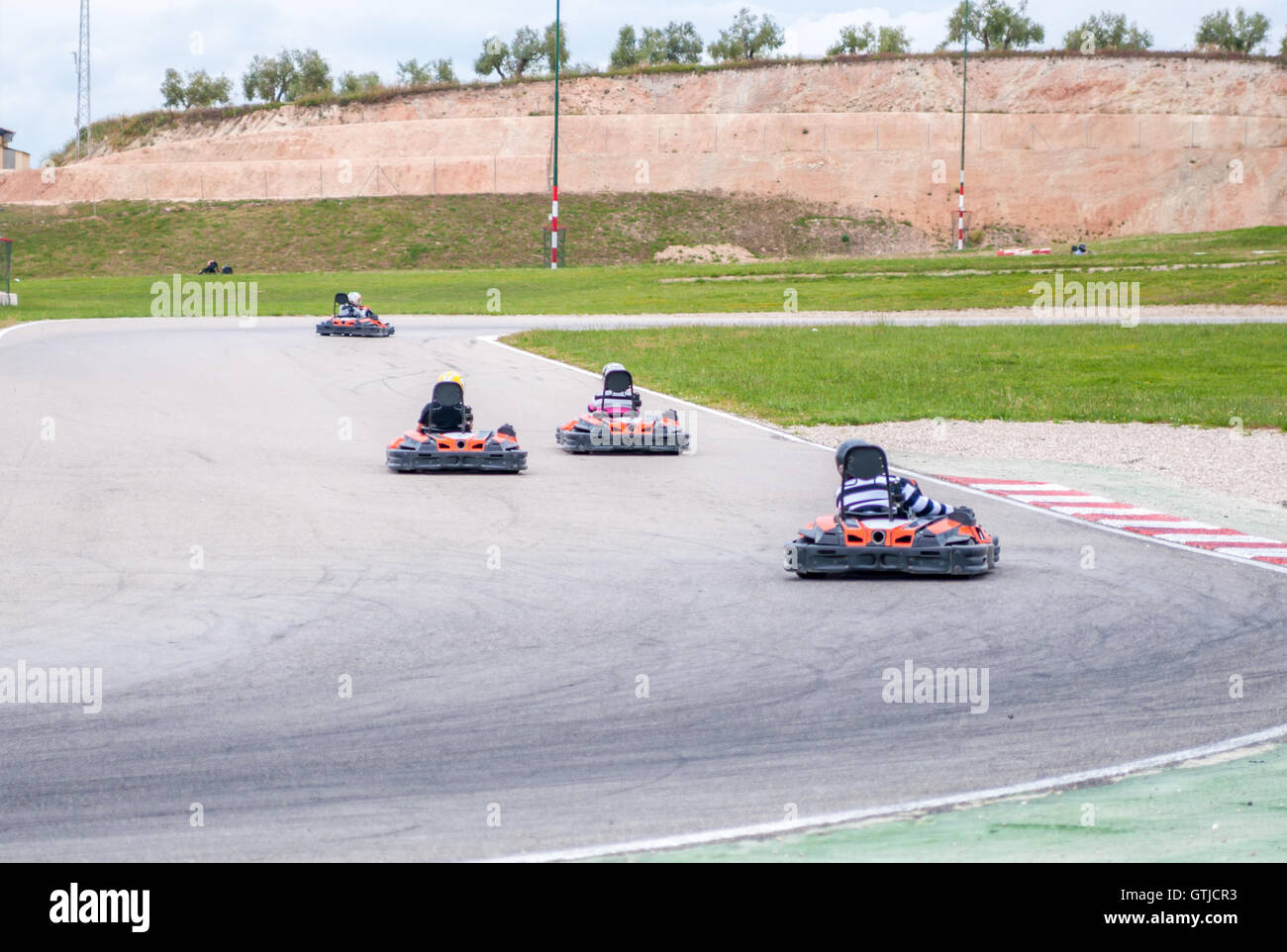 Group of karting racer in a circuit Stock Photo - Alamy