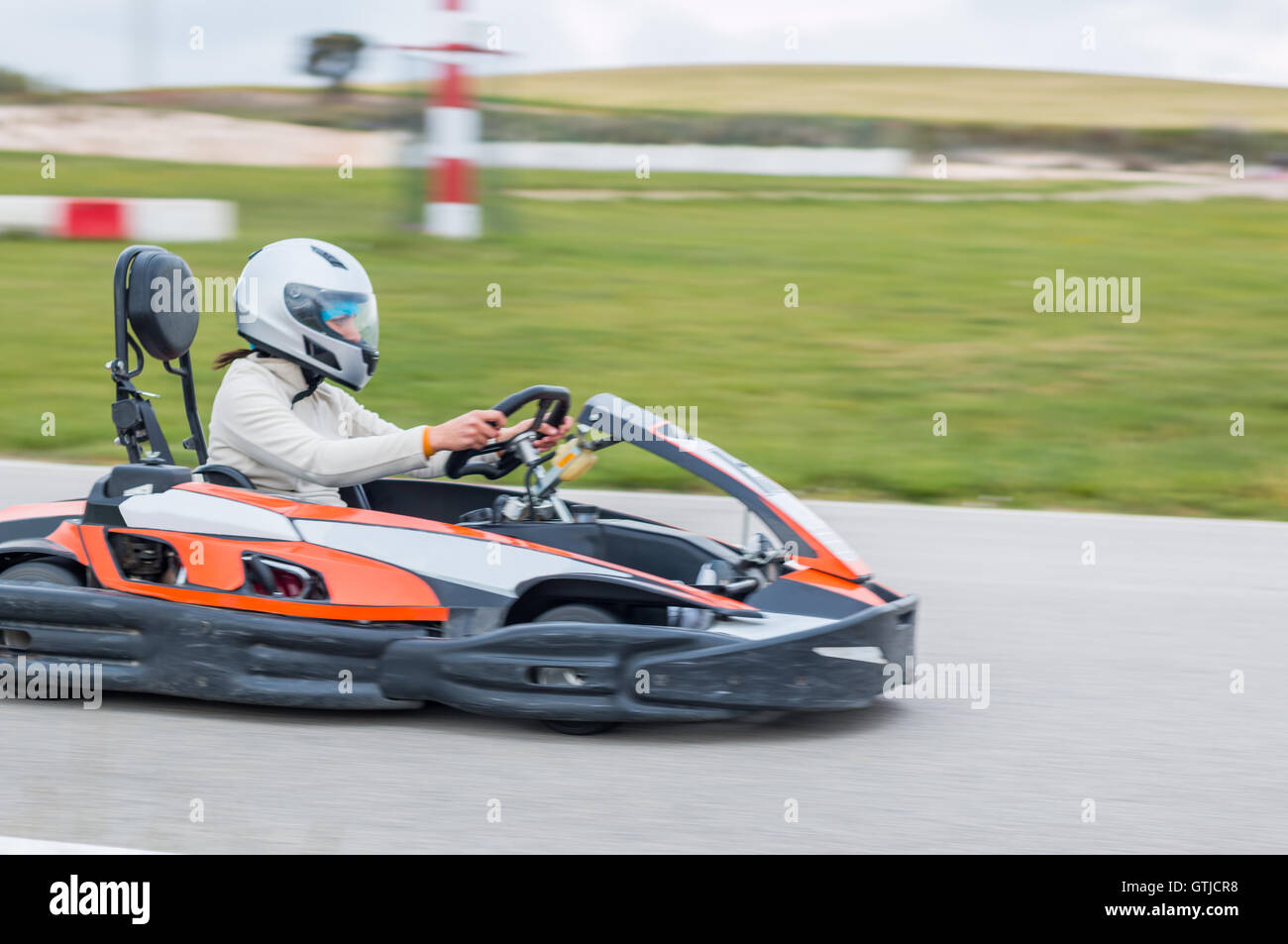 Woman driving fast in a karting circuit Stock Photo - Alamy