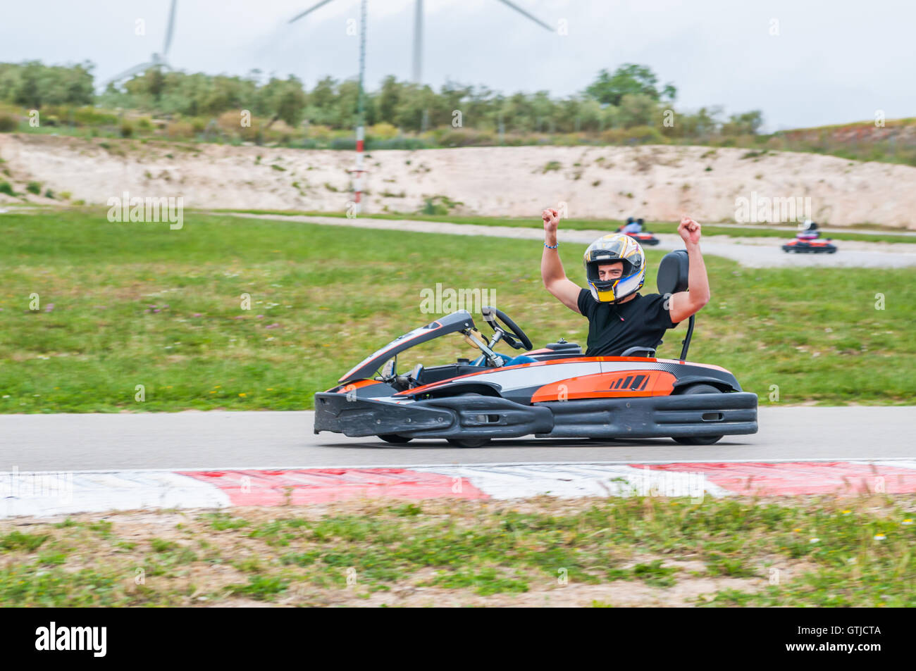 Man with arms up driving a kart. Winner in a karting race Stock Photo ...