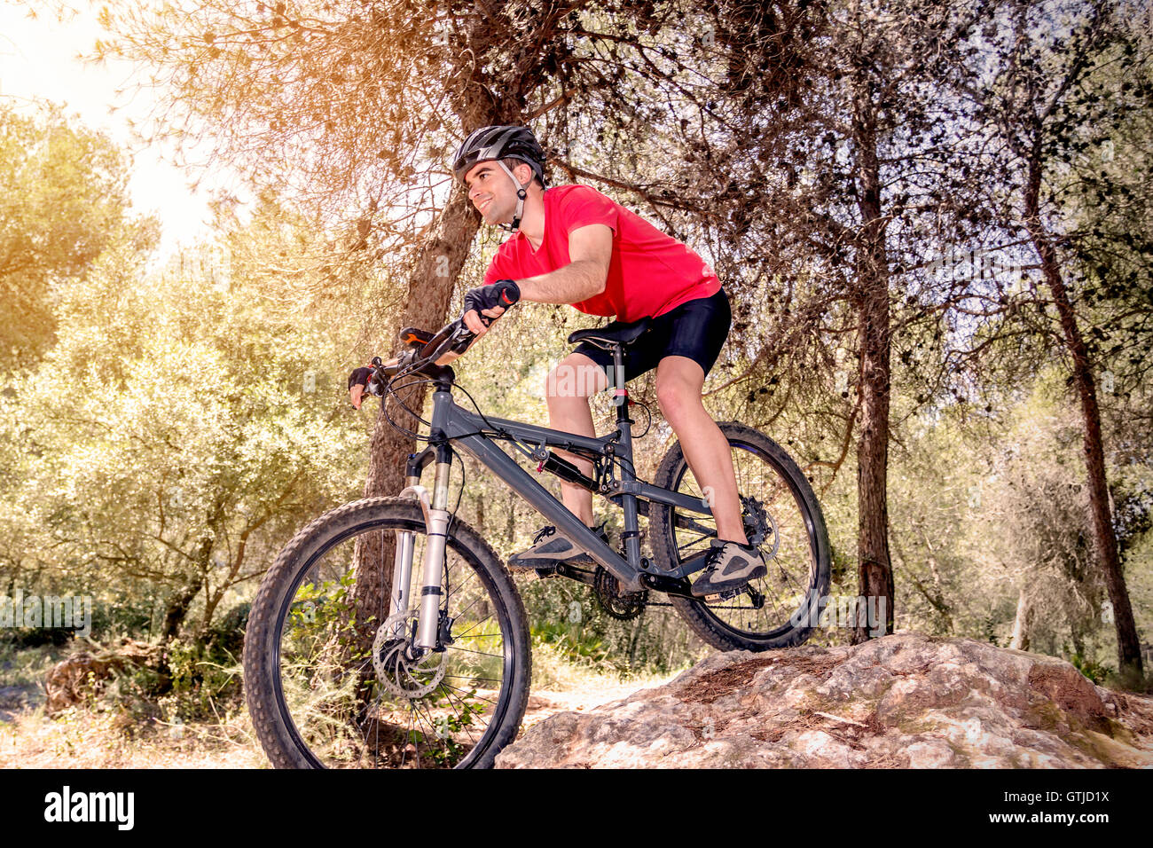 Young adult man riding a bike extreme downhill in nature Stock Photo ...