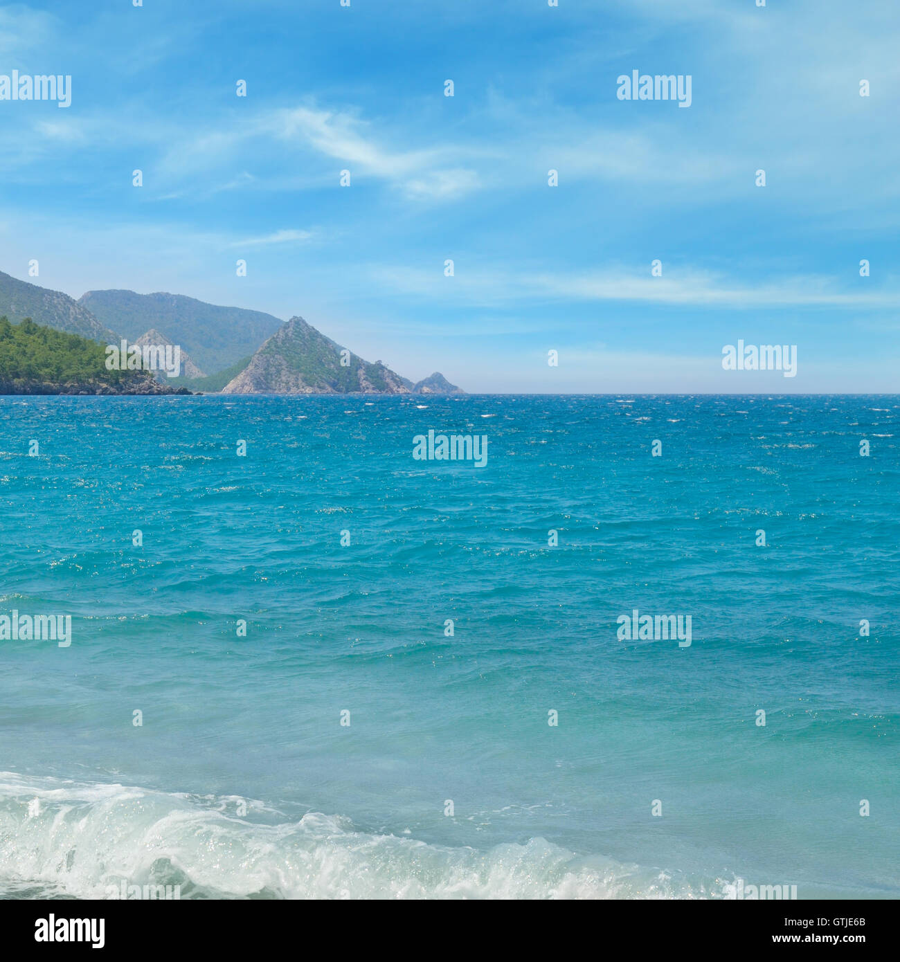 seascape, blue sky and mountainous coast Stock Photo - Alamy