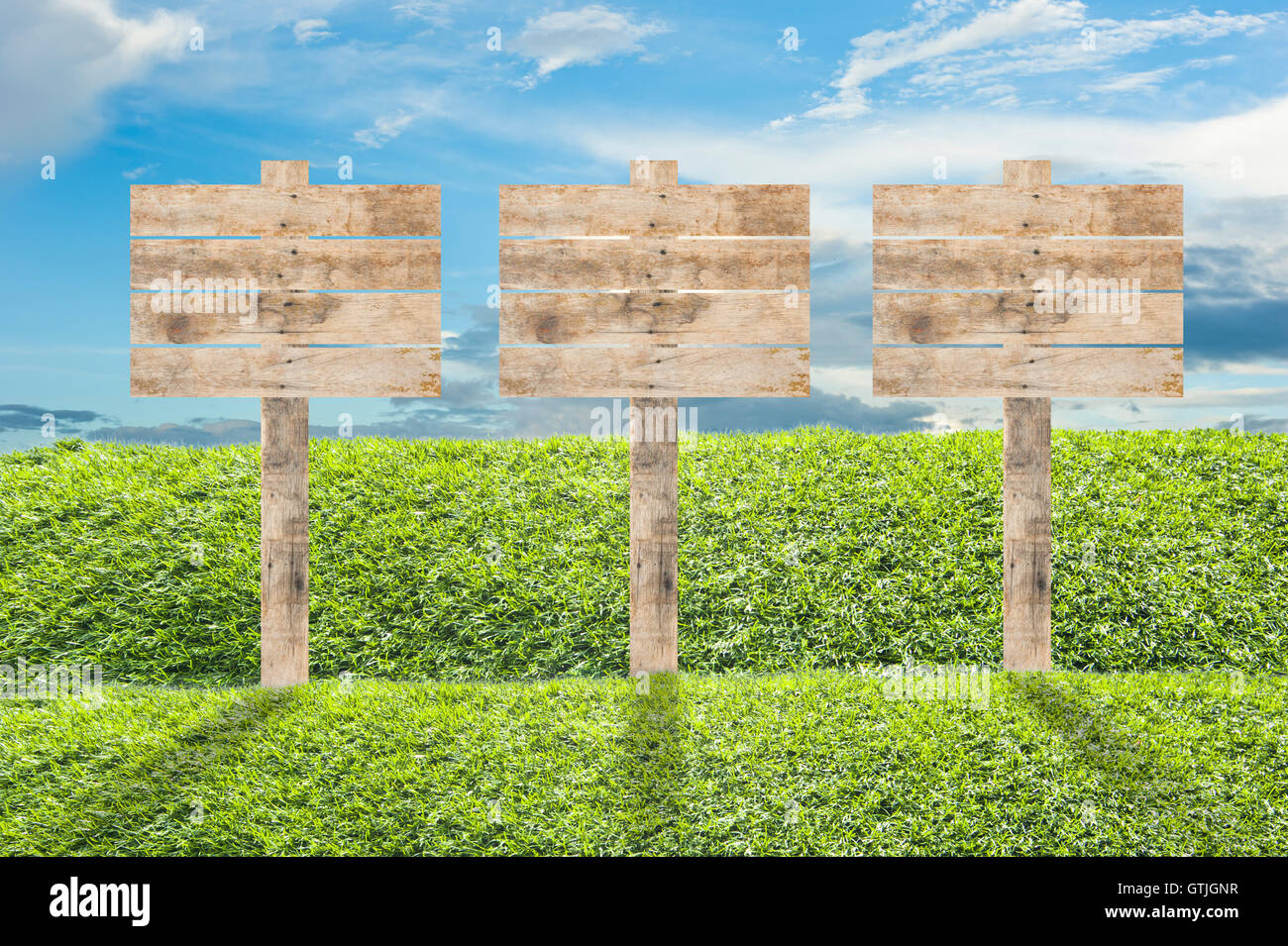Wooden billboard on the grass background Stock Photo - Alamy