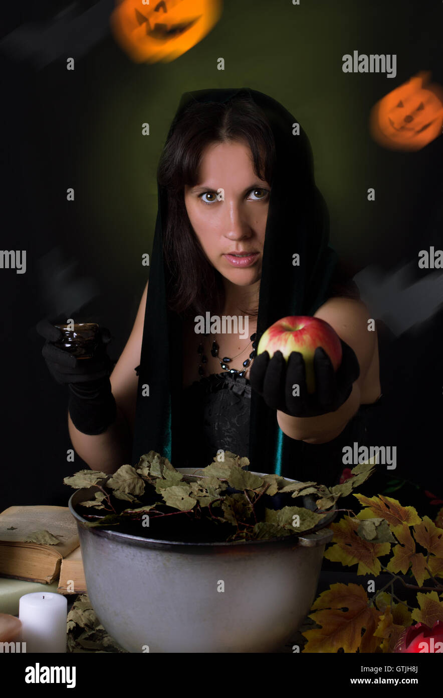 Witch giving poisoned apple Stock Photo - Alamy