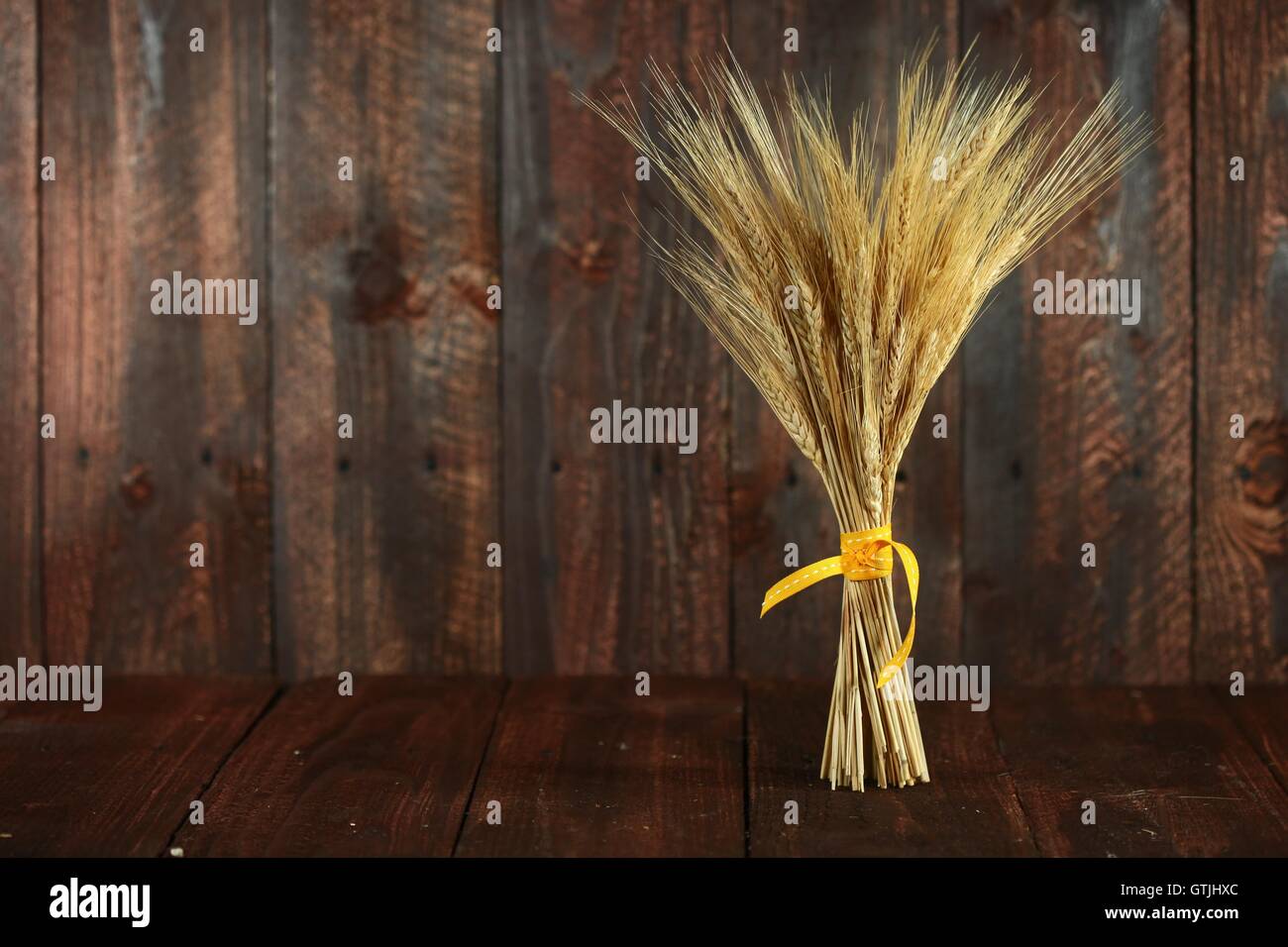 Wheat Grain Stalks on Grunge Wooden Background Stock Photo - Alamy