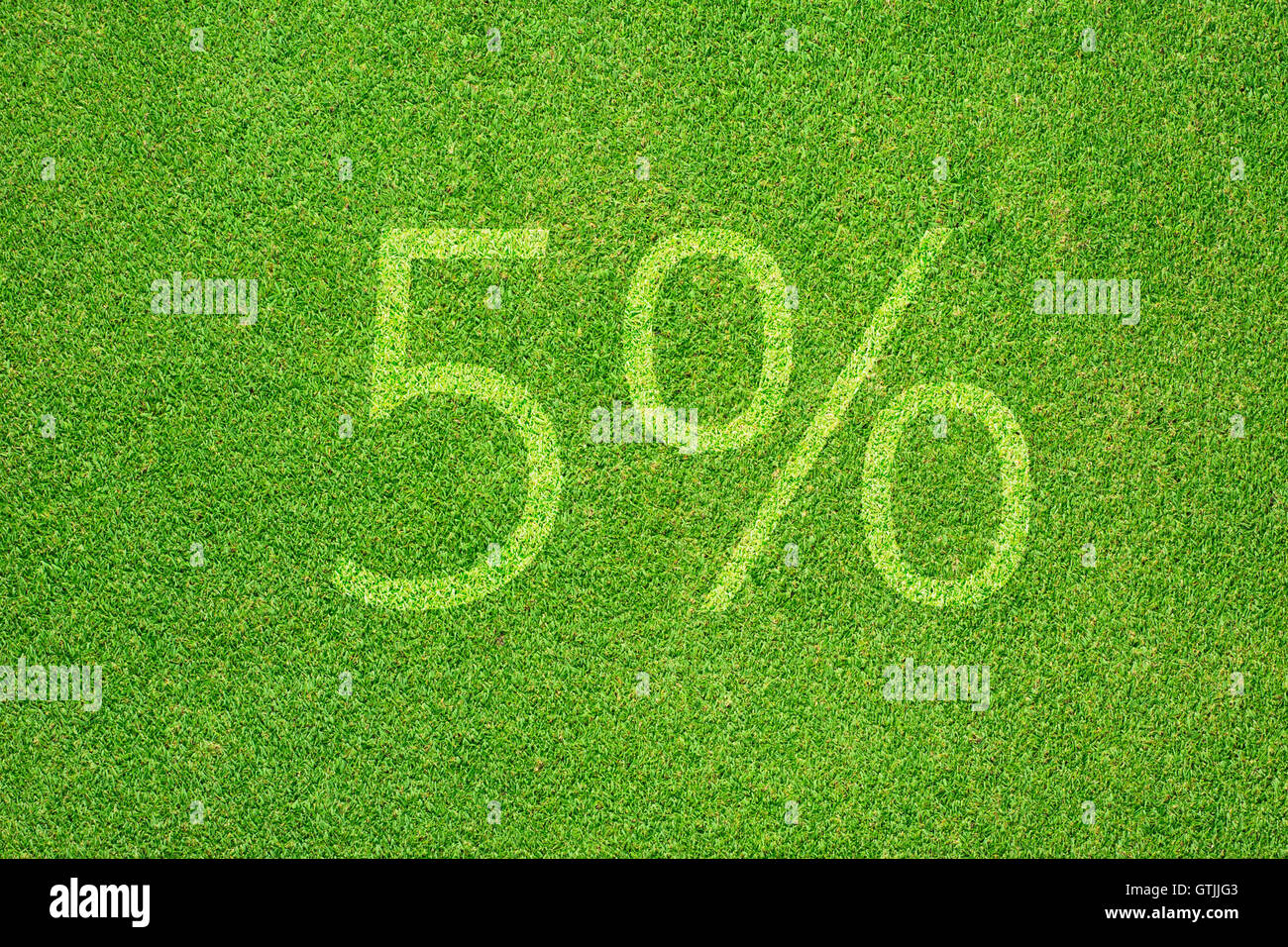 Percent icon on green grass texture and background Stock Photo - Alamy