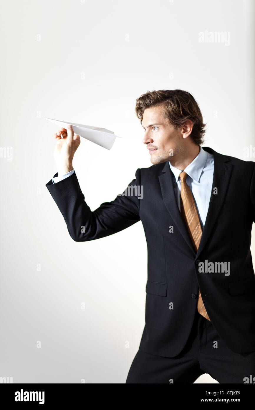 Businessman throwing paper airplane Stock Photo - Alamy