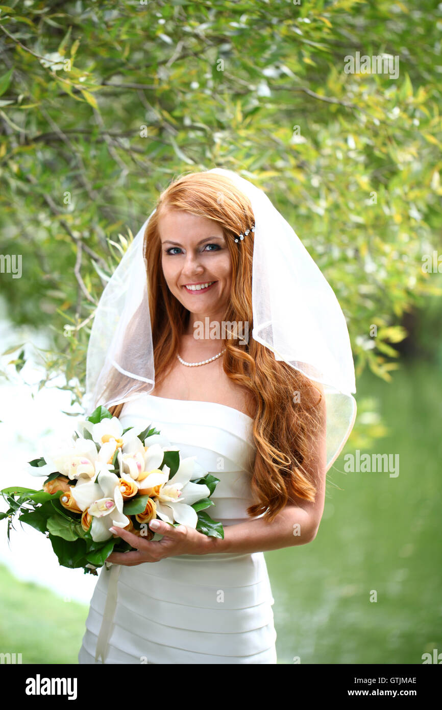Beautiful red hair bride wearing wedding dress Stock Photo - Alamy