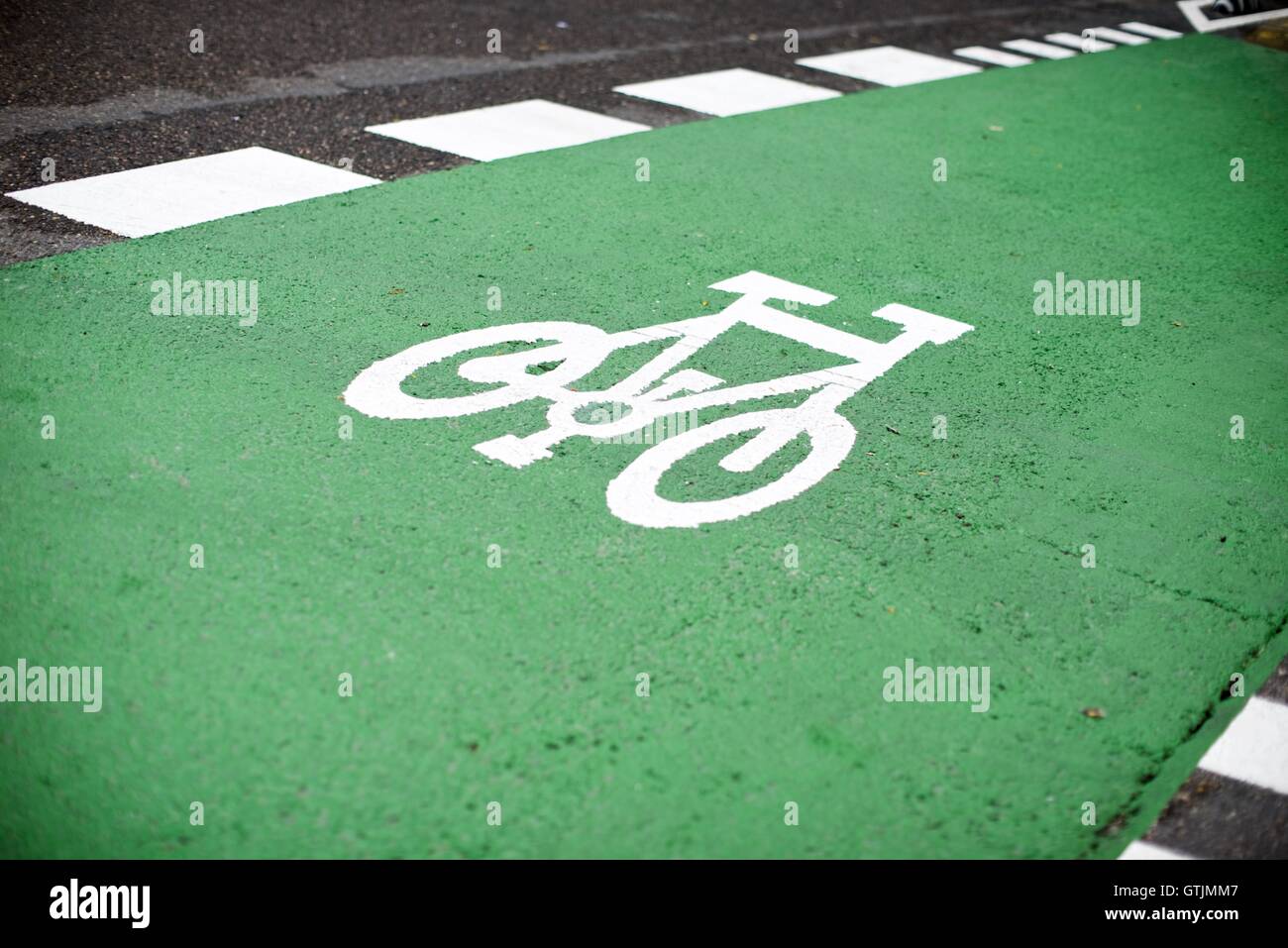 Bike lane sign painted on a street Stock Photo - Alamy