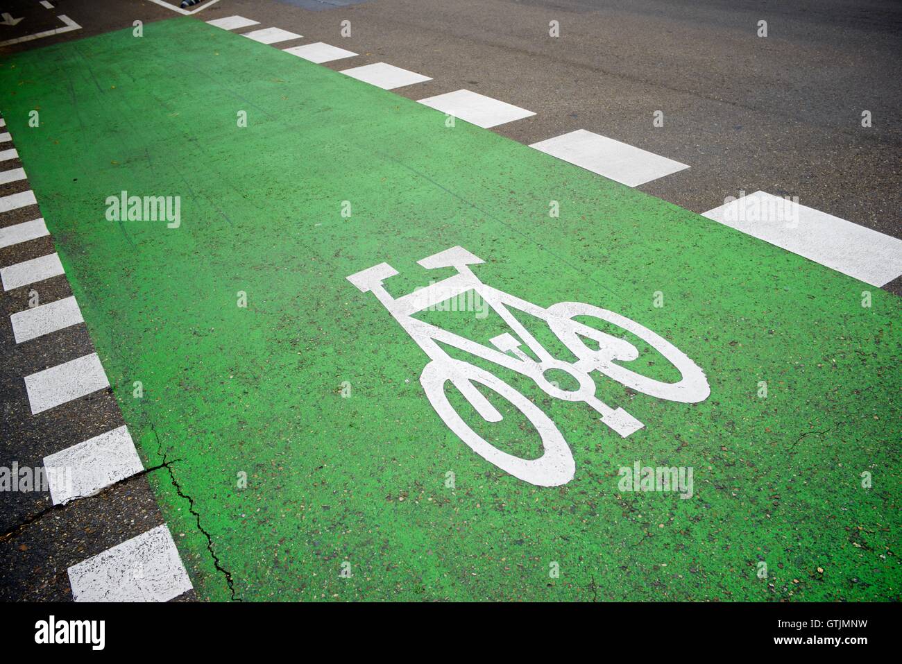 Bike lane sign painted on a street Stock Photo - Alamy