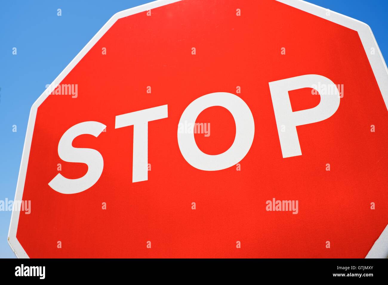 Stop traffic sign with clear blue sky Stock Photo - Alamy