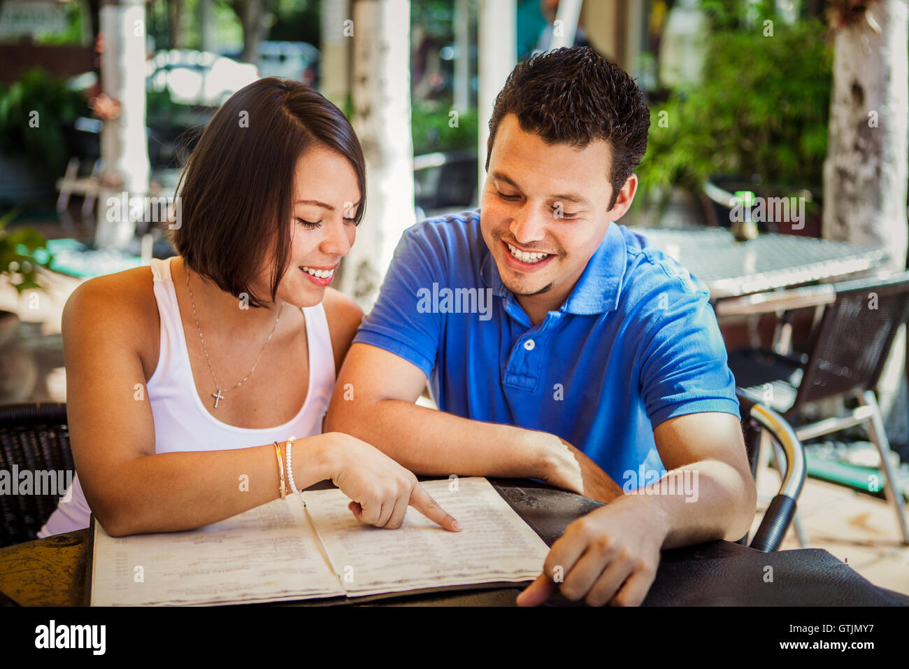 Beautiful latin couple in a restaurant Stock Photo - Alamy