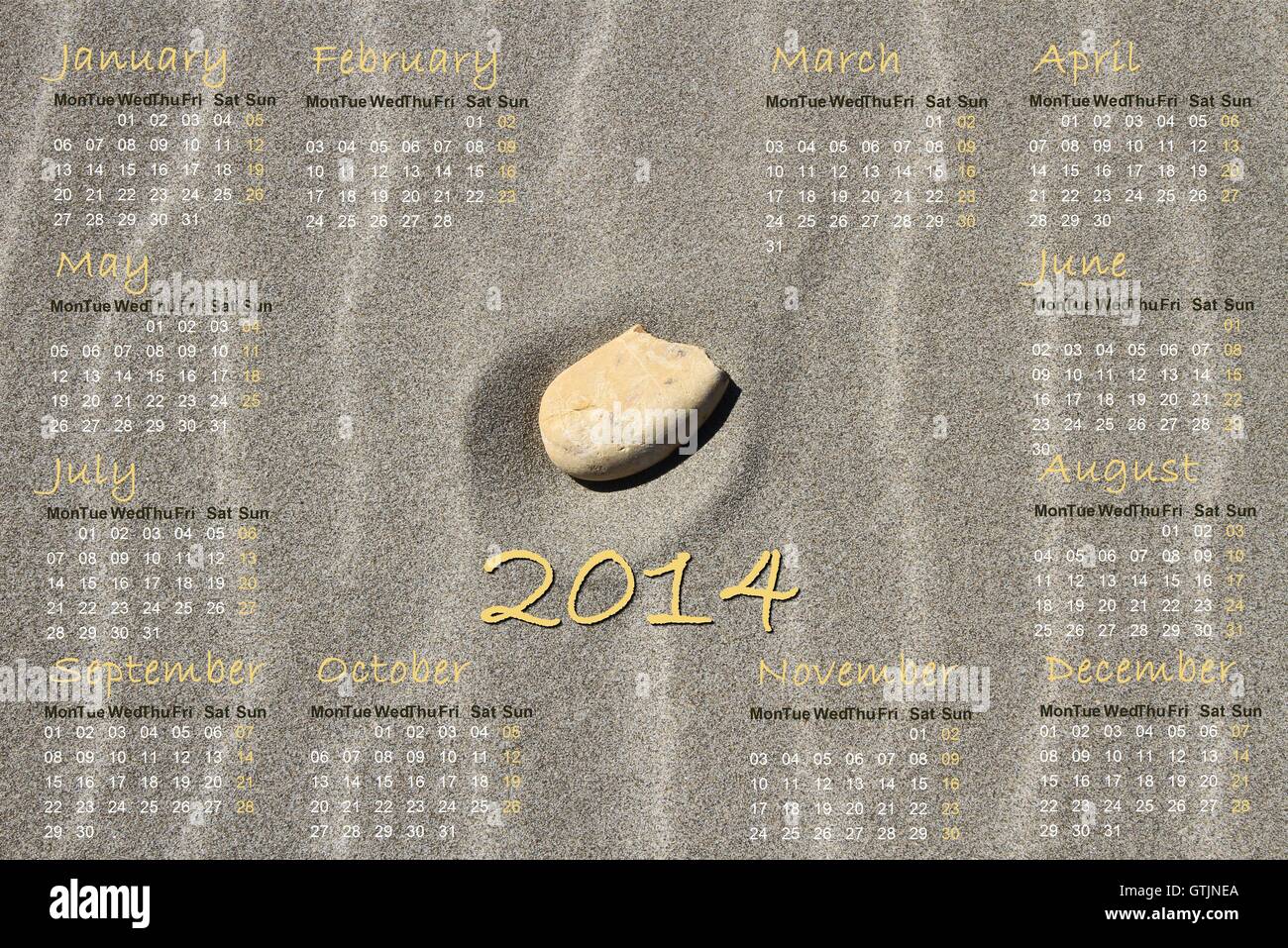 2014 english calendar with stone on sand Stock Photo - Alamy