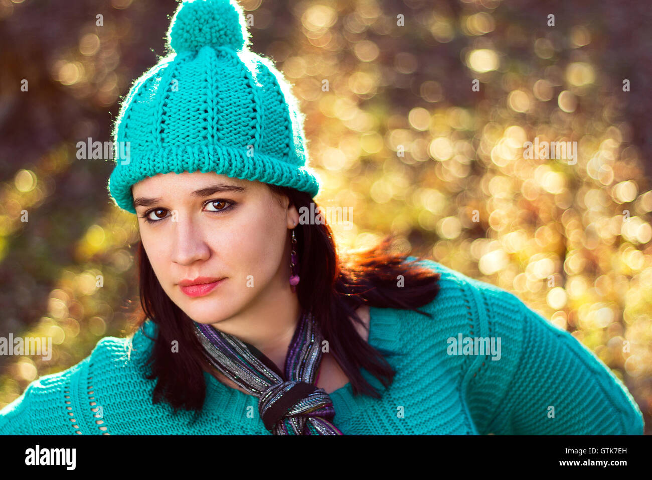 A portrait of a stylish and beautiful woman in matching hat and sweater ...