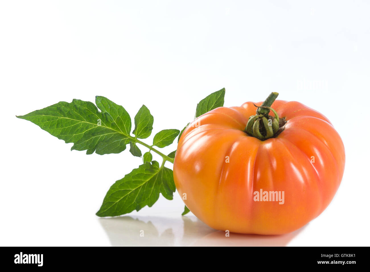 An isolated yellow and orange zebra heirloom tomato Stock Photo - Alamy