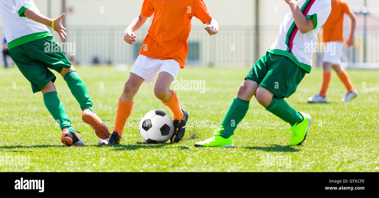 Young boys children in uniforms playing youth soccer football game ...