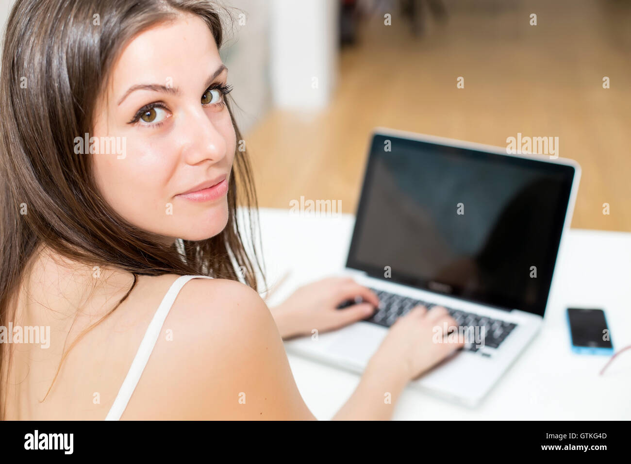 Pretty young woman working on laptop in the office Stock Photo - Alamy