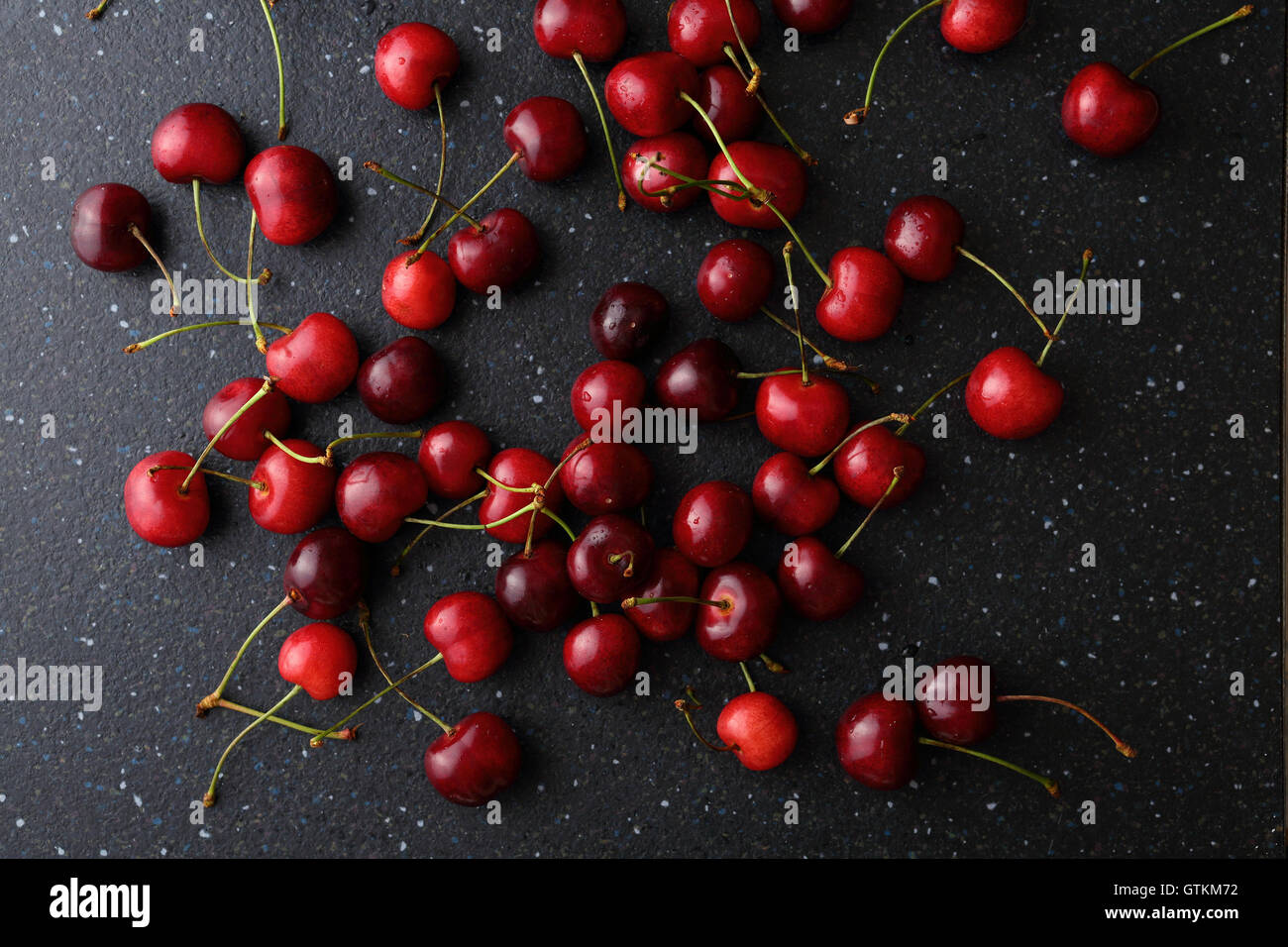 Ripe cherry on black food background, top view Stock Photo - Alamy