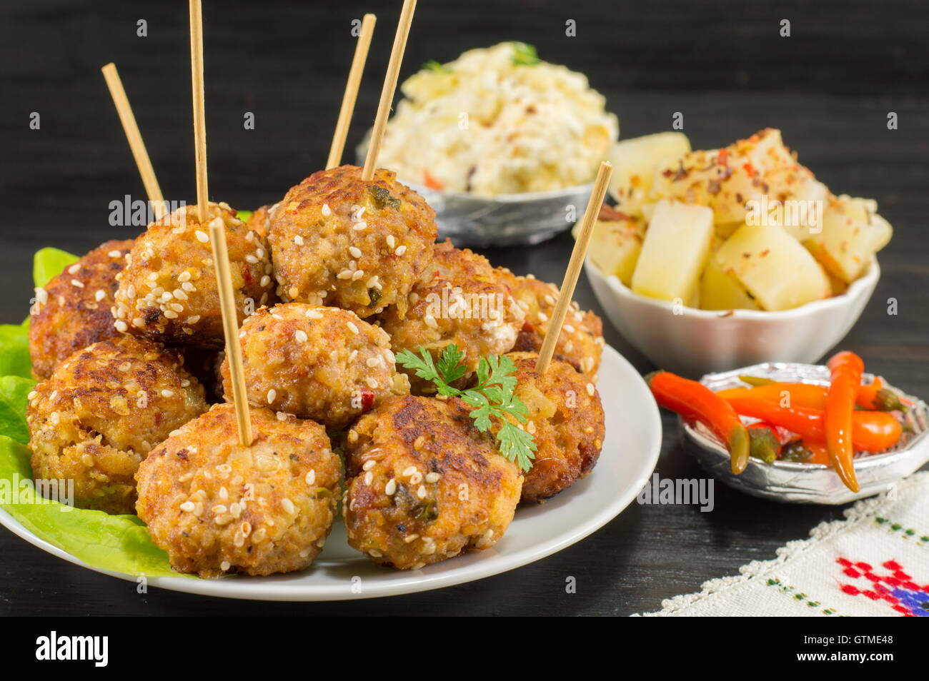 Meatballs on sticks in a plate with vegetables Stock Photo - Alamy