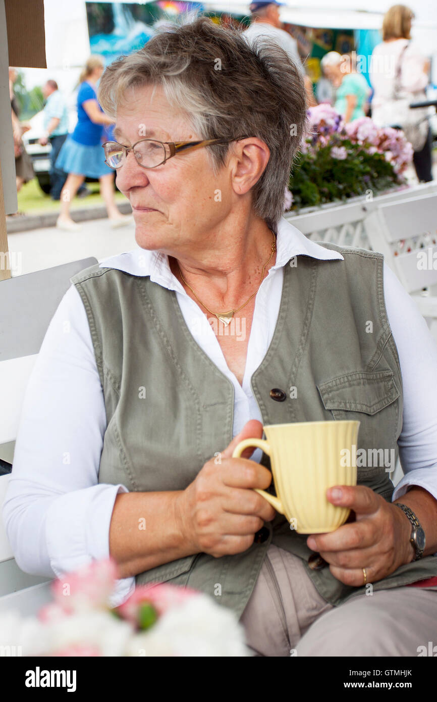 Old woman drinking coffee Stock Photo - Alamy